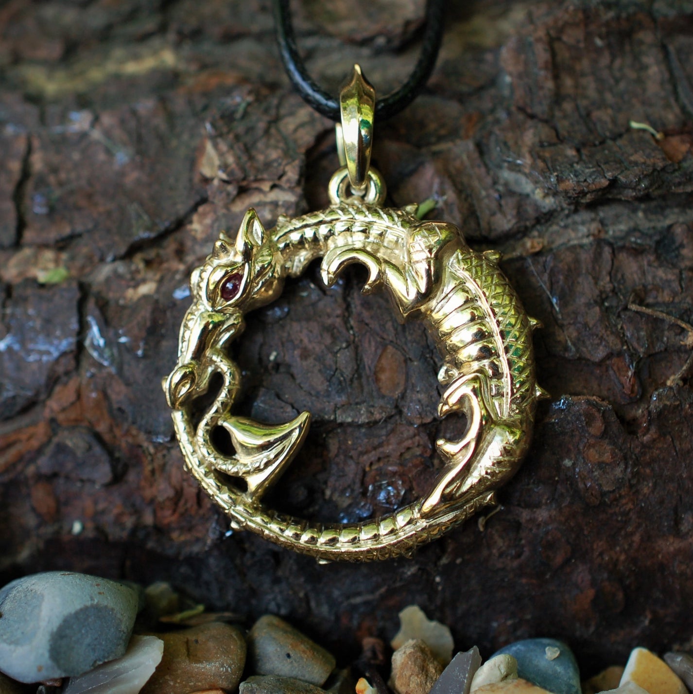 Mid-sized dragon pendant with a bail for chains and a ruby eye ...